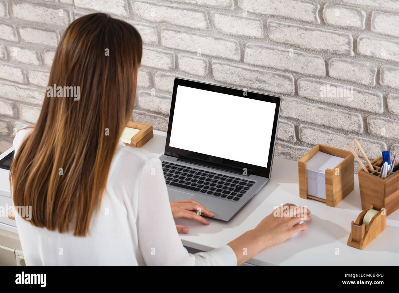 Rear View Of A Young Businesswoman Using Laptop With Blank White Screen ...