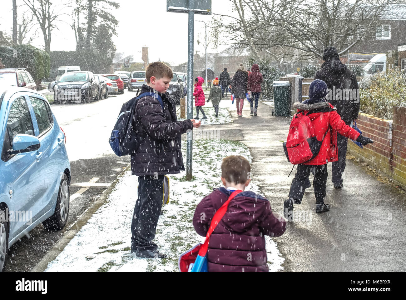 Snow falling in Reading during the school pickup as school children ...