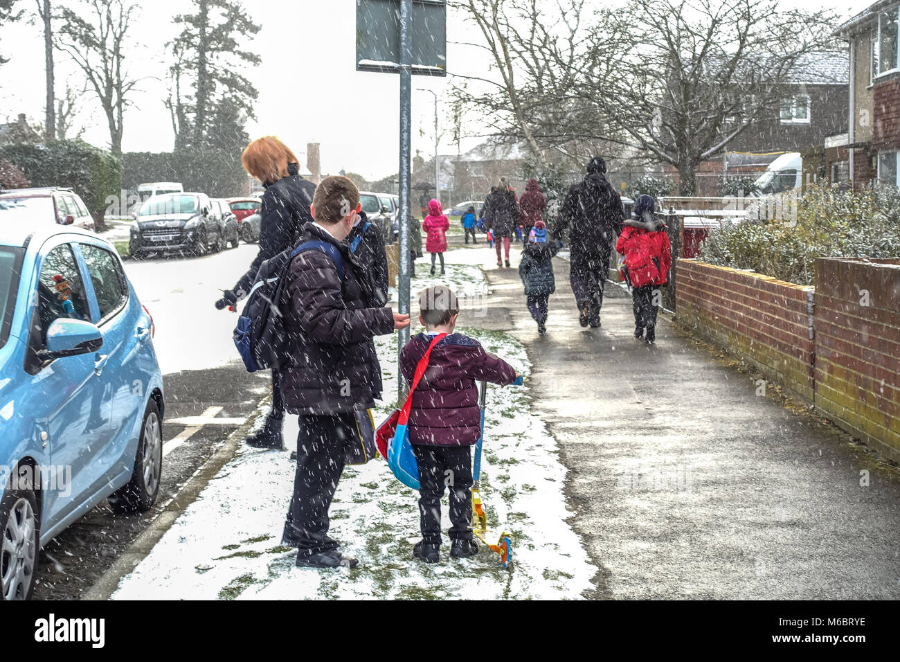 Snow falling in Reading during the school pickup as school children ...
