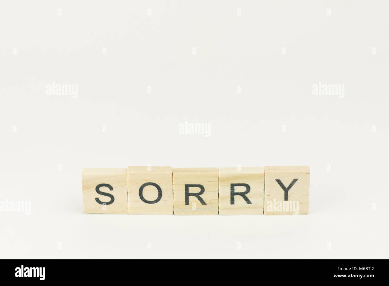 Text wooden blocks spelling the word sorry on white background Stock ...