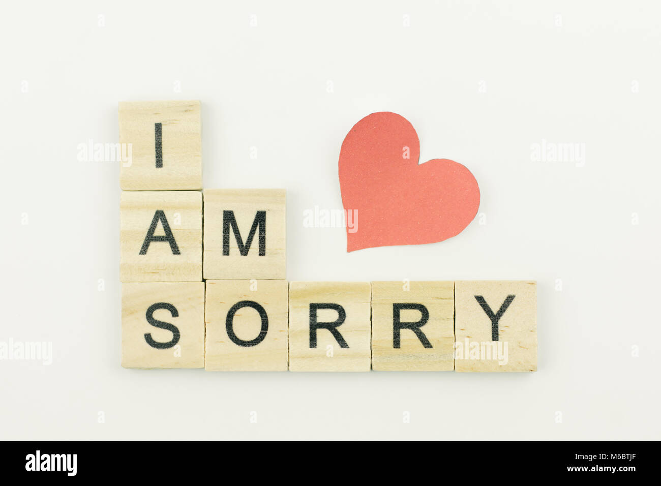Text wooden blocks spelling the word I am sorry on white background ...