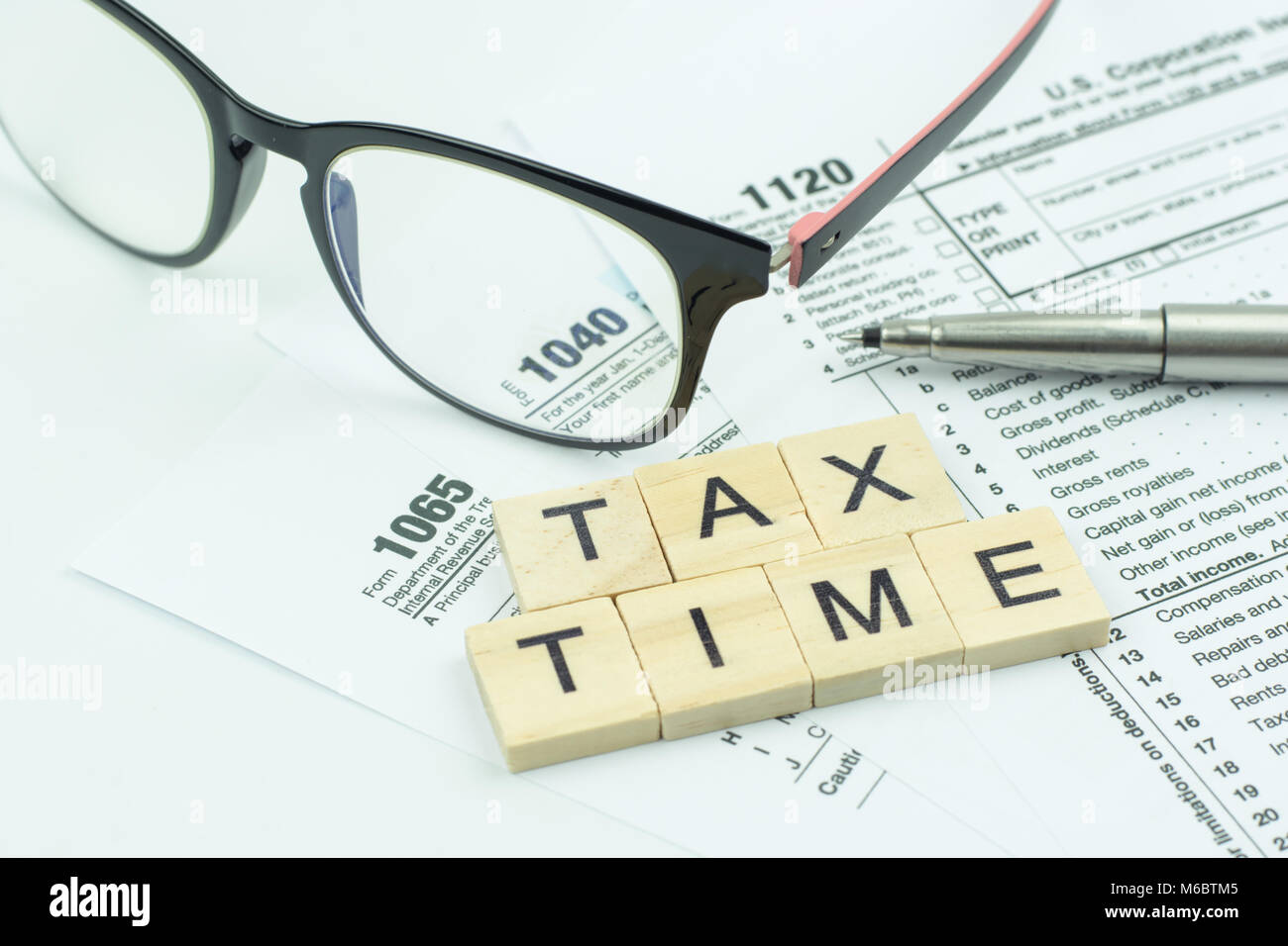 Tax Time text wooden block with on U.S. tax form Stock Photo - Alamy