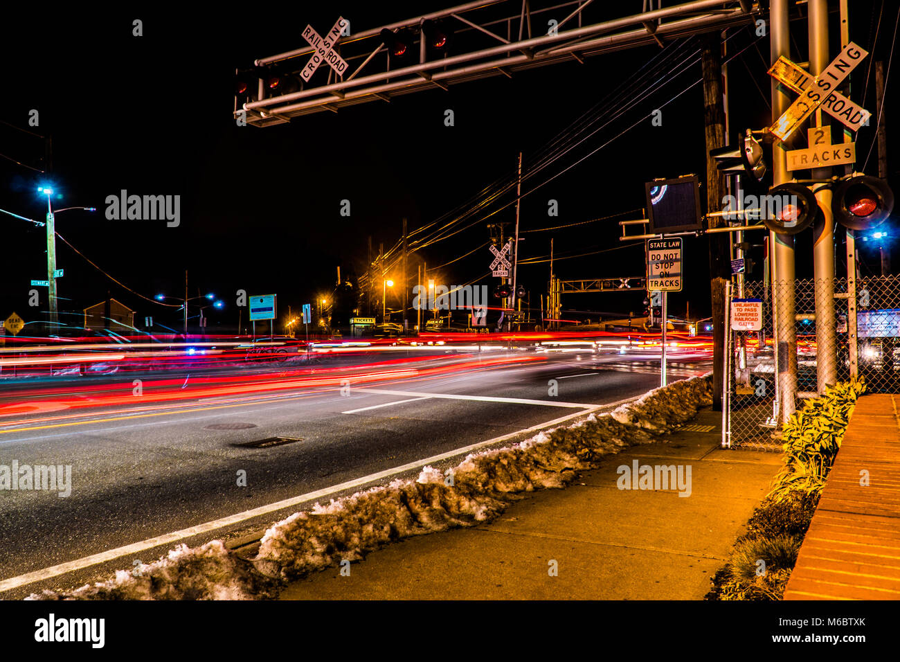 Traffic passing railroad crossing tracks on a busy road during rush ...