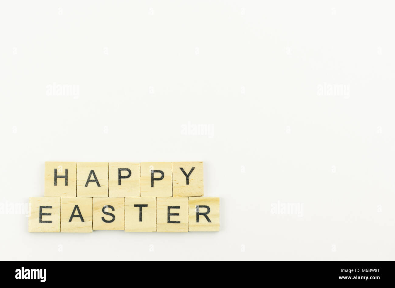 Text wooden blocks spelling the word happy easter on white background ...