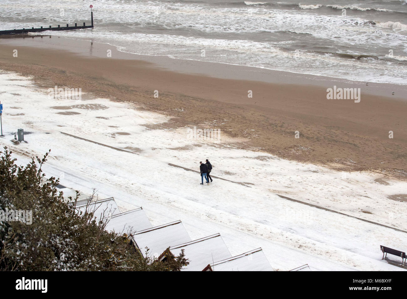 People walk along the snow on Bournemouth beach in Dorset, as extreme ...