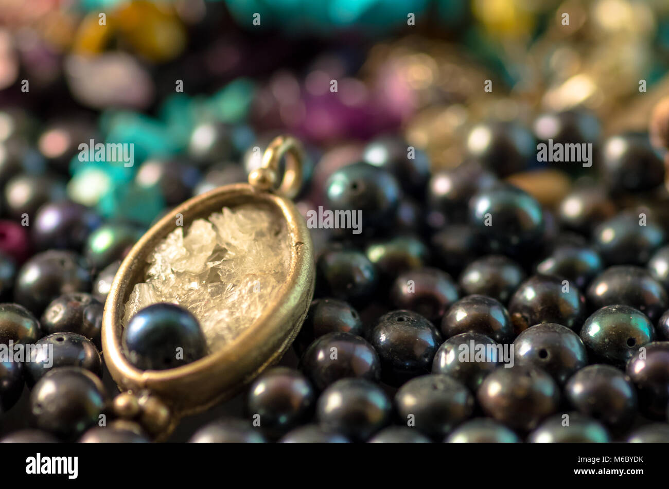 Necklace on top of a stack of black pearls Stock Photo - Alamy