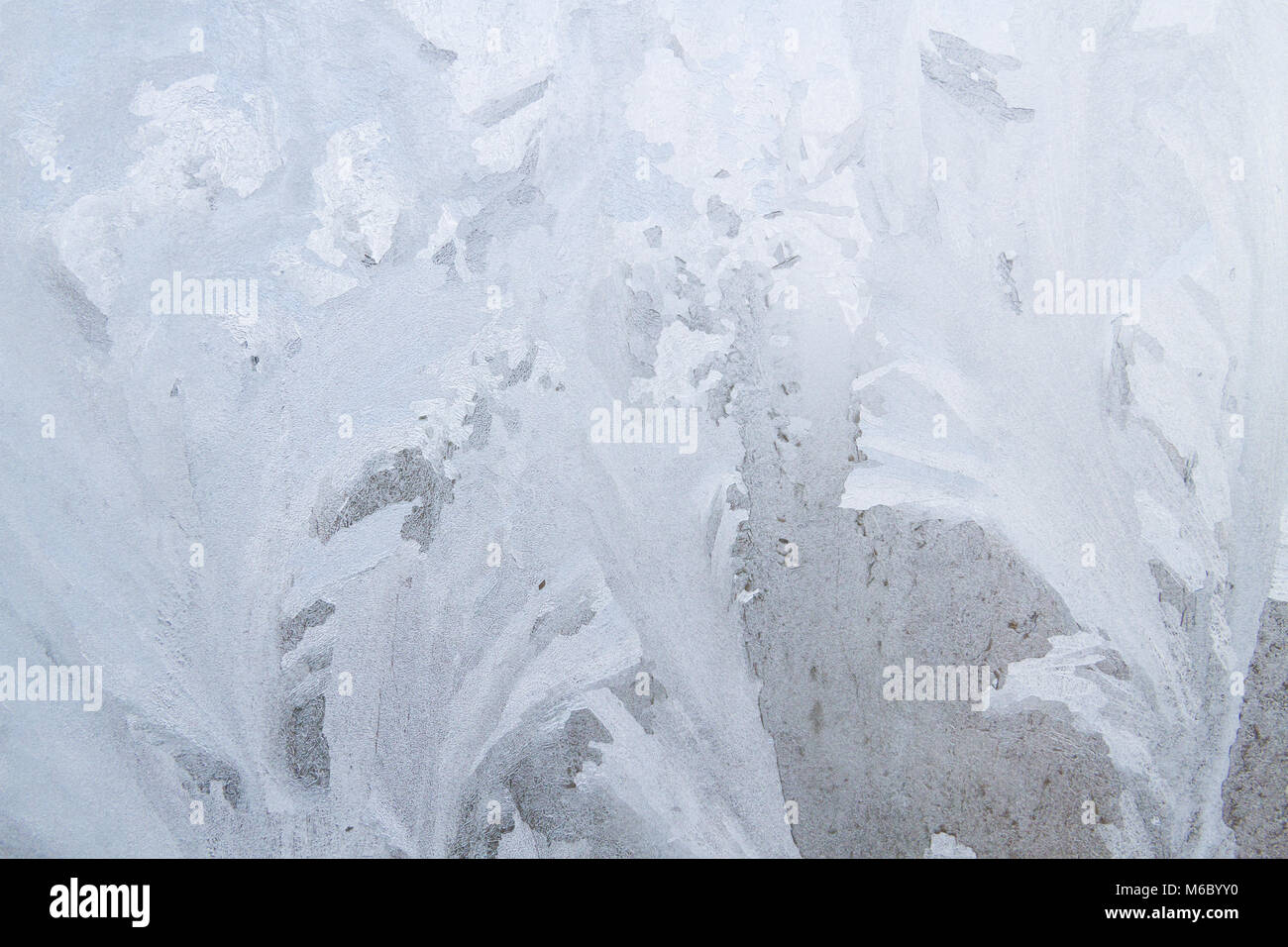 Winter frosty patterns on the frozen ice window Stock Photo - Alamy