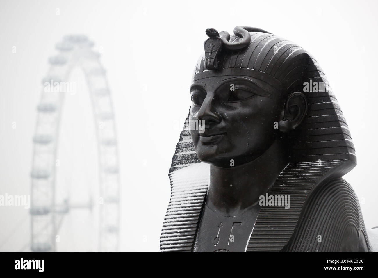 A dusting of snow on a sphinx on the Victoria Embankment, London, as ...