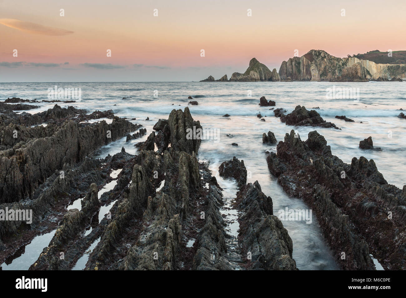the beach of Gueirua, a disturbing landscape of sharp rocks that emerge ...