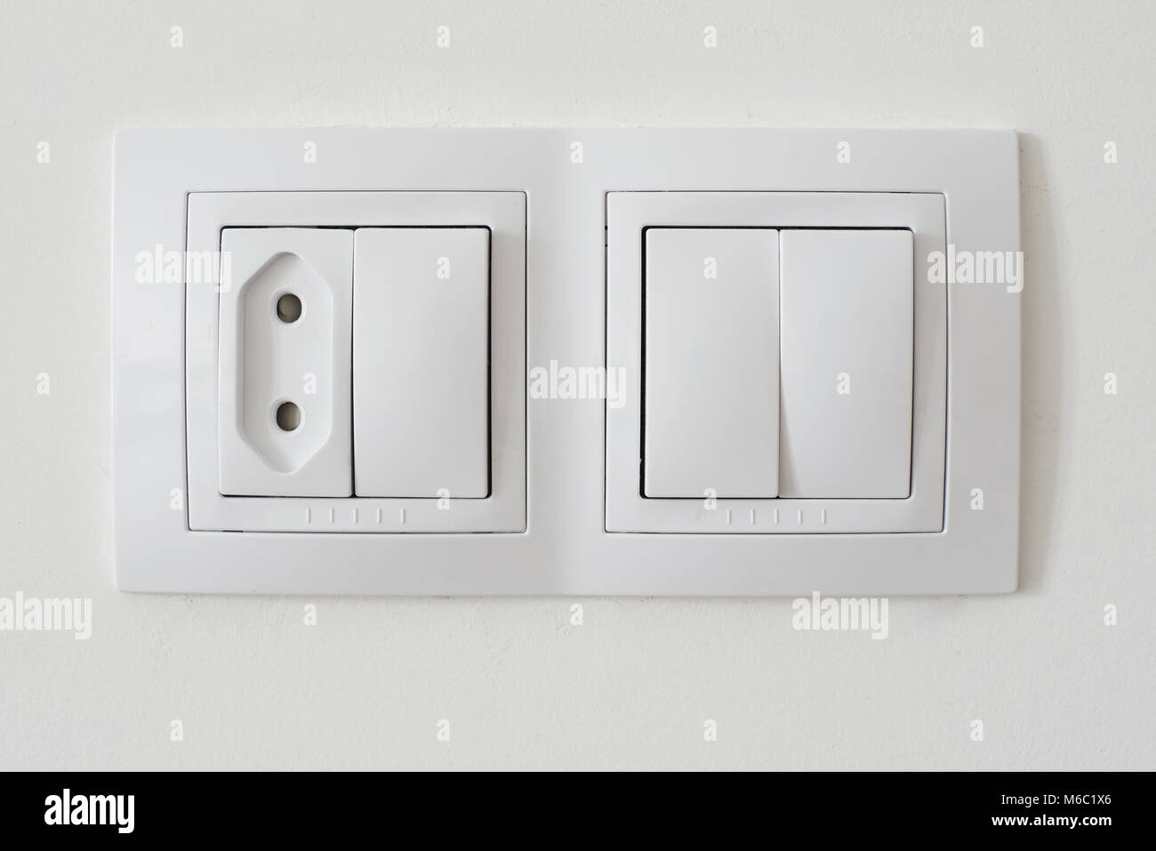 Light switch socket on white wall close up view Stock Photo - Alamy