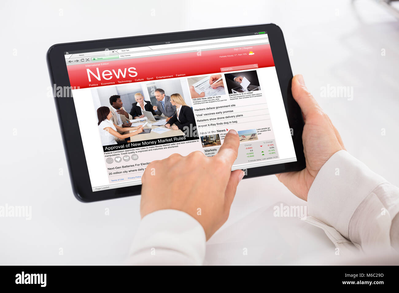 Close-up Of A Person Reading News On Digital Tablet Stock Photo - Alamy