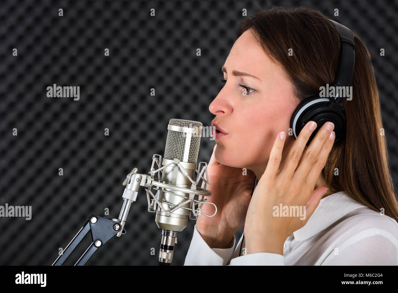 Portrait Of A Young Woman Singer With Headphones In Front Of The ...