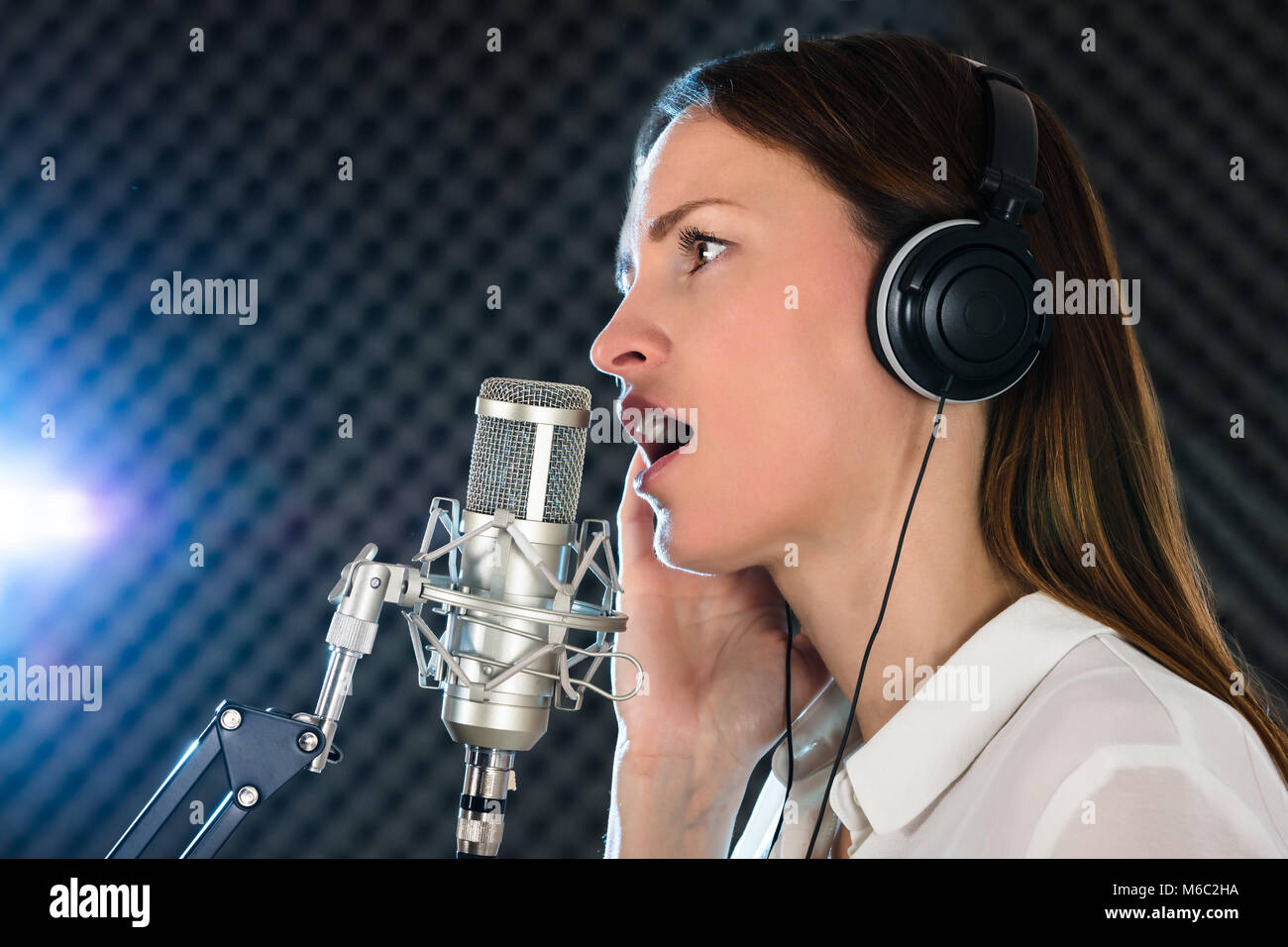 Portrait Of A Young Woman Singer With Headphones In Front Of The ...