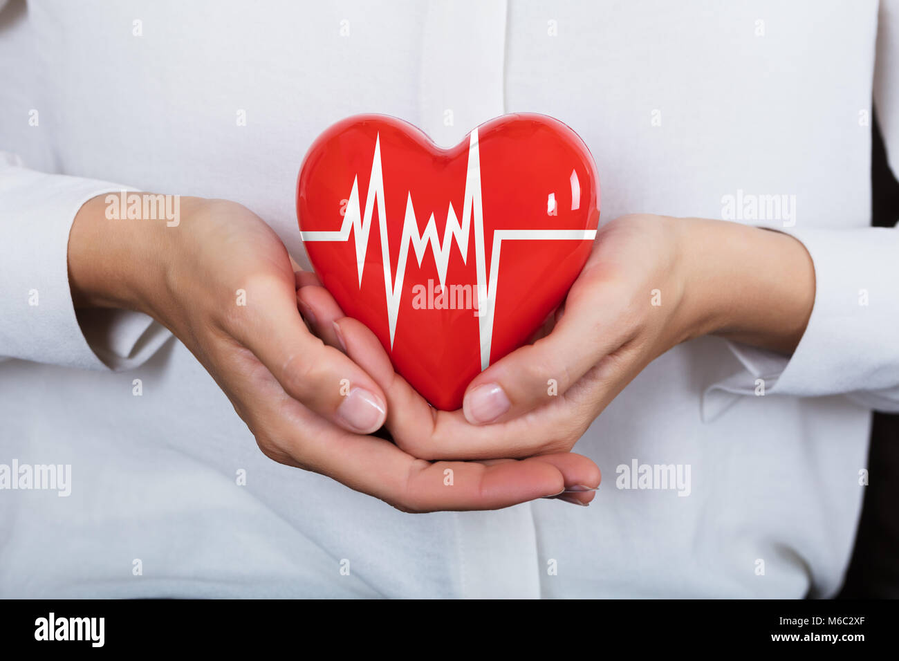 Close-up Of A Person Holding Heart With Pulse Chart In Palm Stock Photo ...
