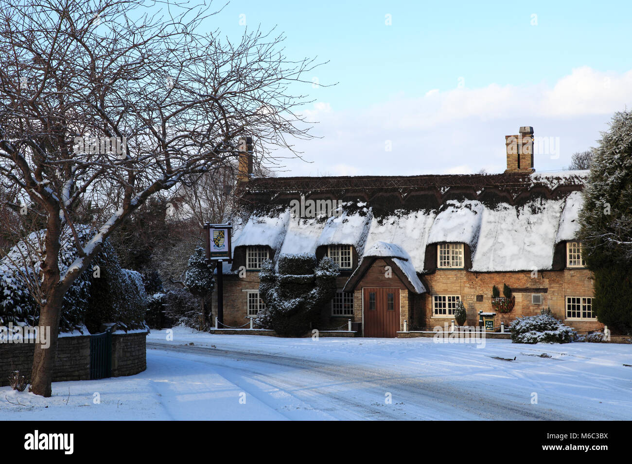 Winter snow covering the Fitzwilliam Arms Pub, Marholm village ...