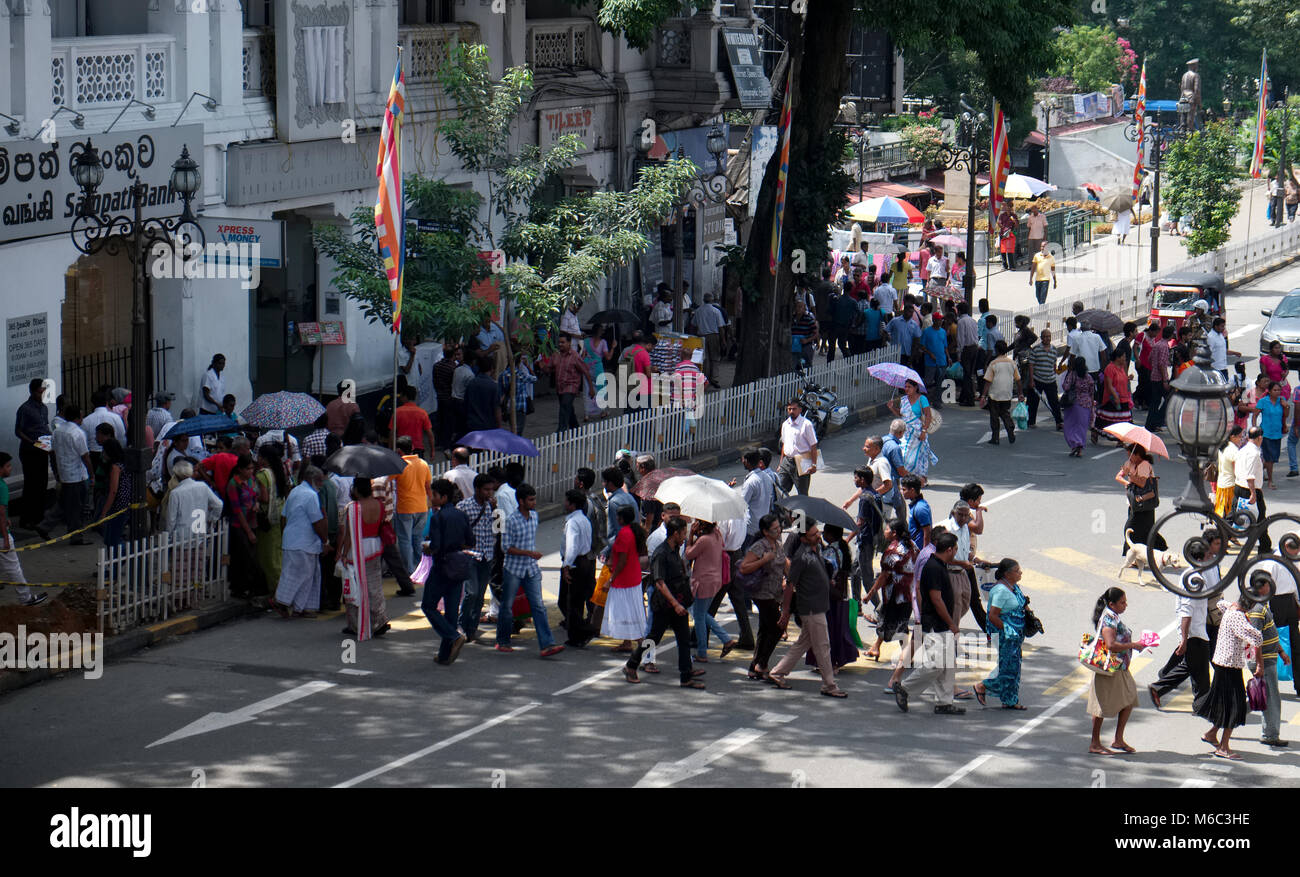 People cross the street at a pedestrian crossing in Kandy in Sri Lanka ...