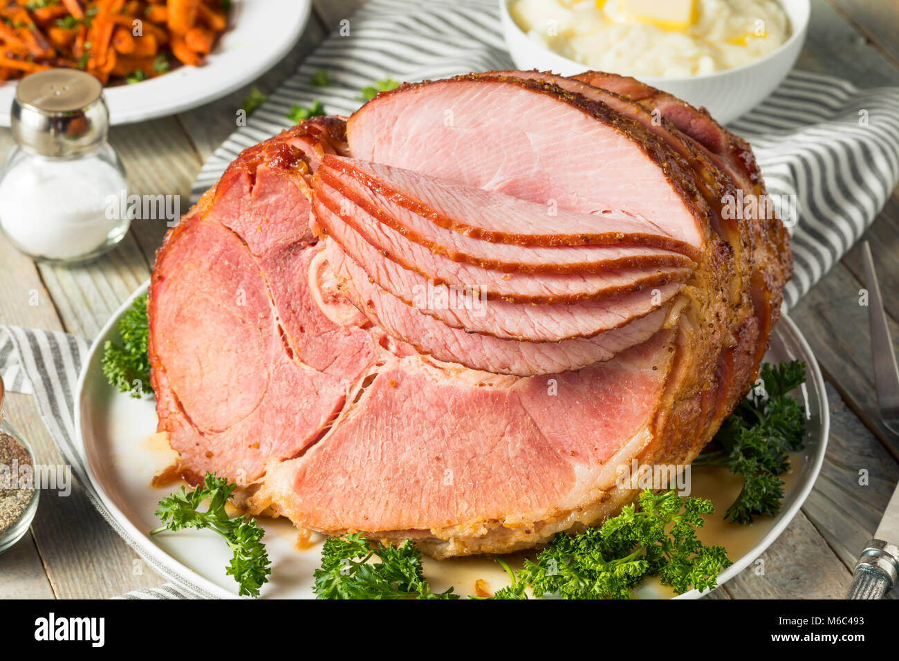 Homemade Glazed Easter Spiral Cut Ham with Carrots and Potatoes Stock ...