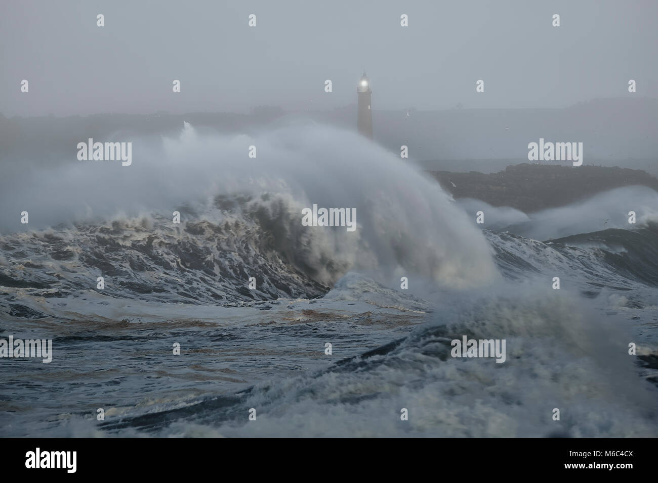 The Mouro island lighthouse during a storm. Big waves, more of 10 ...