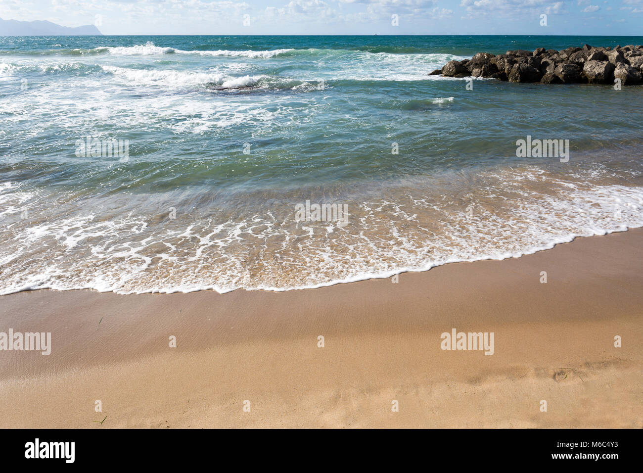 crystal clear sea and frothy waves on the beaches of Palermo in Sicily ...