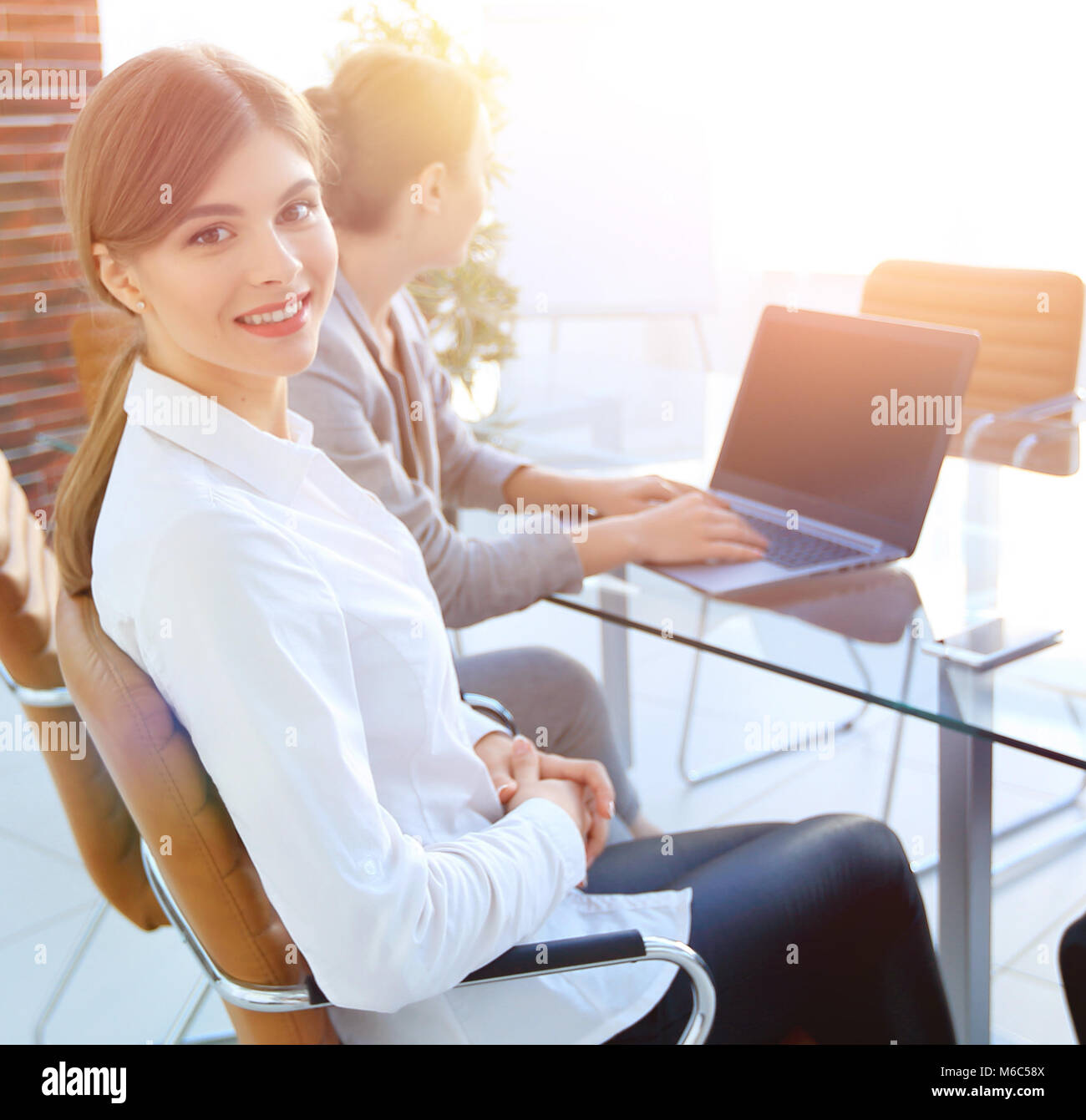 office workers sitting behind a Desk Stock Photo - Alamy