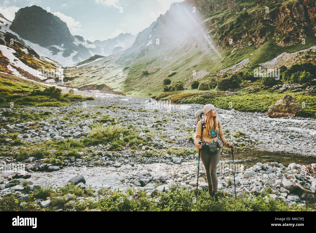 Woman backpacker hiking in mountains adventure travel lifestyle concept ...