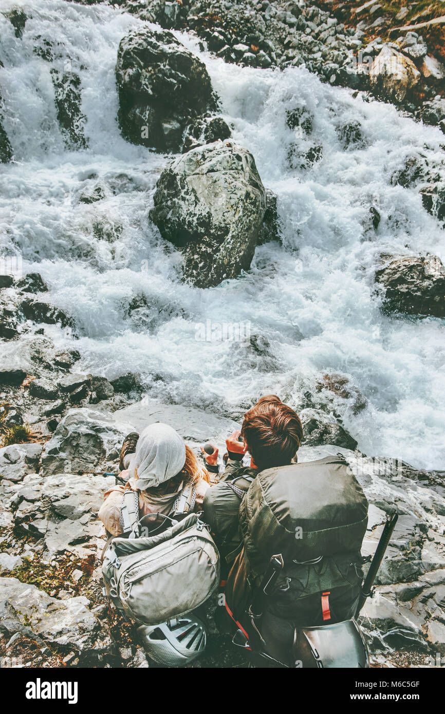 Couple adventurers relaxing at mountain river together love and Travel ...