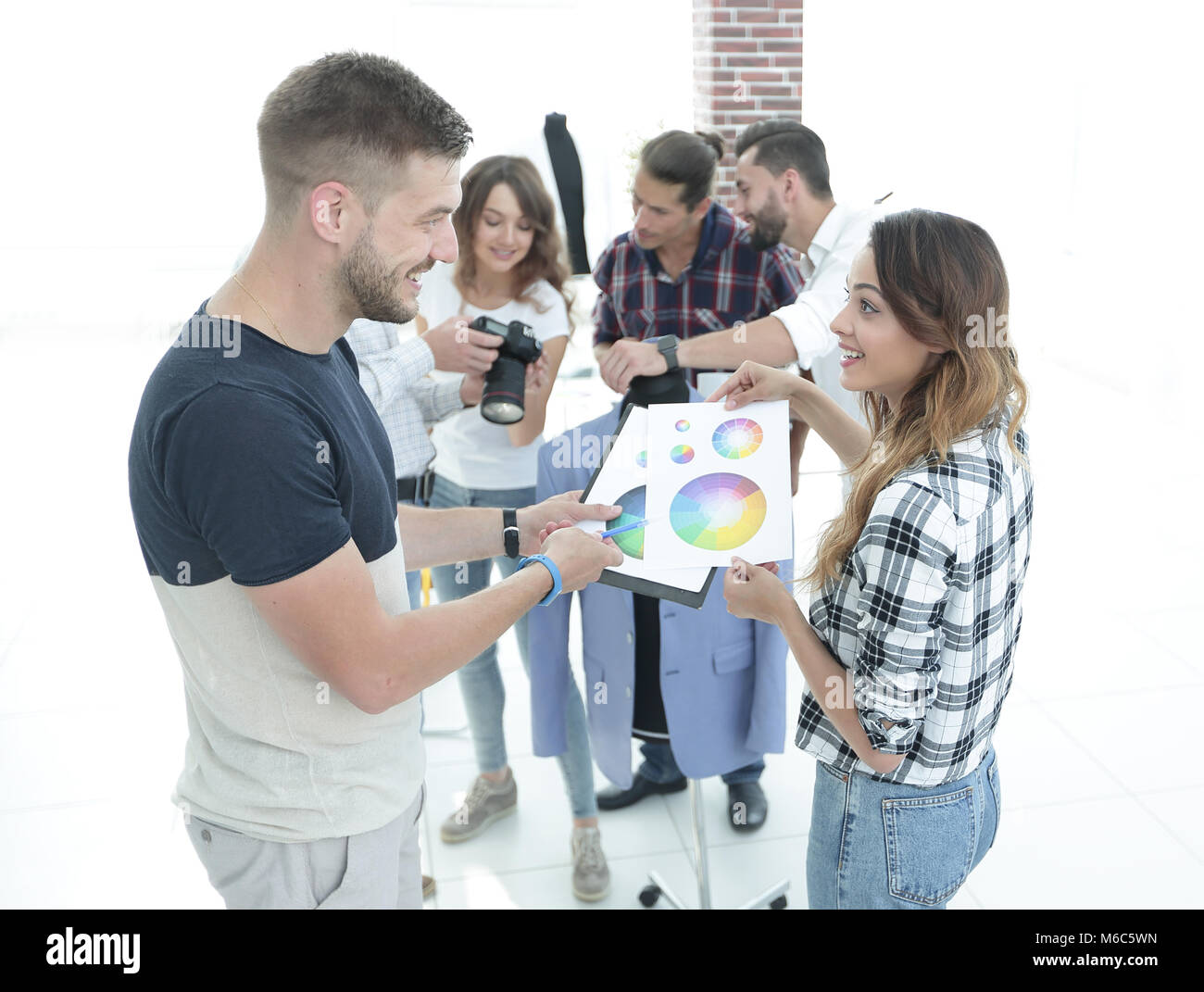 designers discussing the color palette in the Studio Stock Photo - Alamy