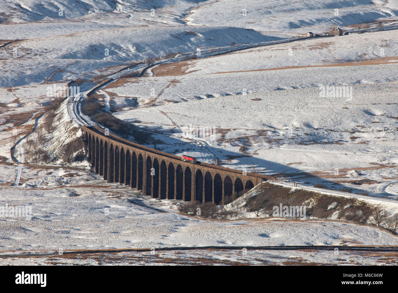 A DB cargo class 66 locomotive crosses Ribblehead viaduct running light ...