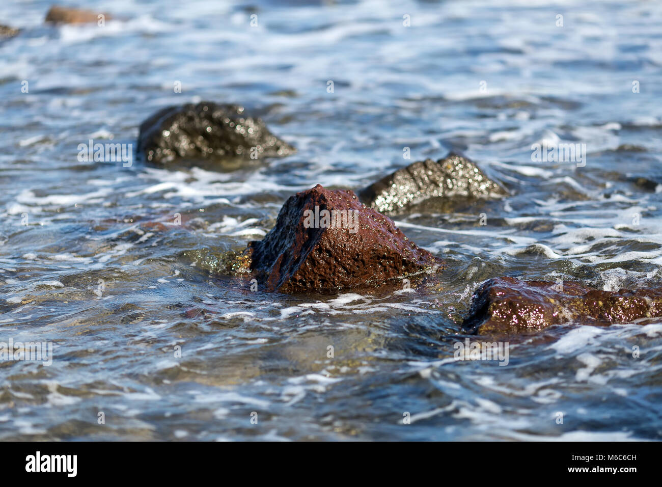 Rock surrounded by water in the sea Stock Photo - Alamy