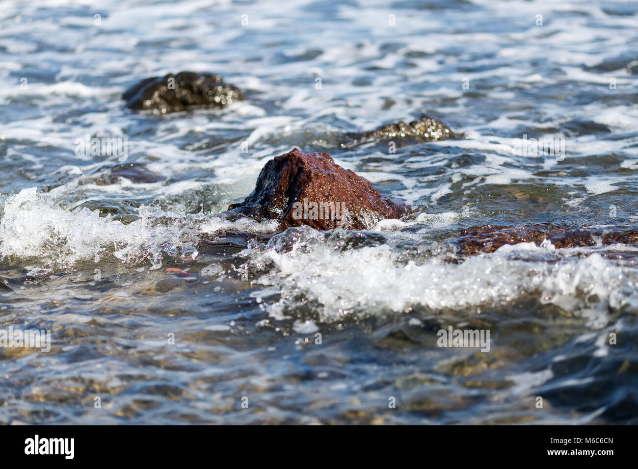 Rock surrounded by water in the sea Stock Photo - Alamy