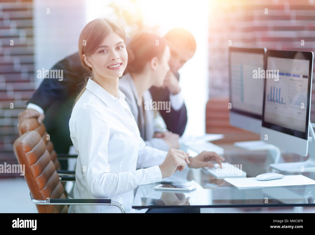 young employee sitting at a Desk Stock Photo - Alamy
