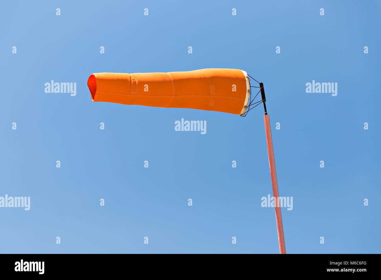 orange wind sock against blue sky Stock Photo - Alamy