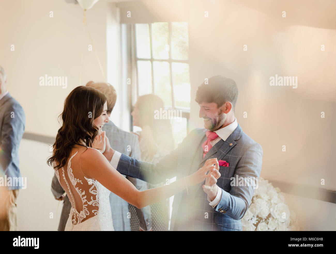 Bride and groom are enjoying dancing together on their wedding day ...