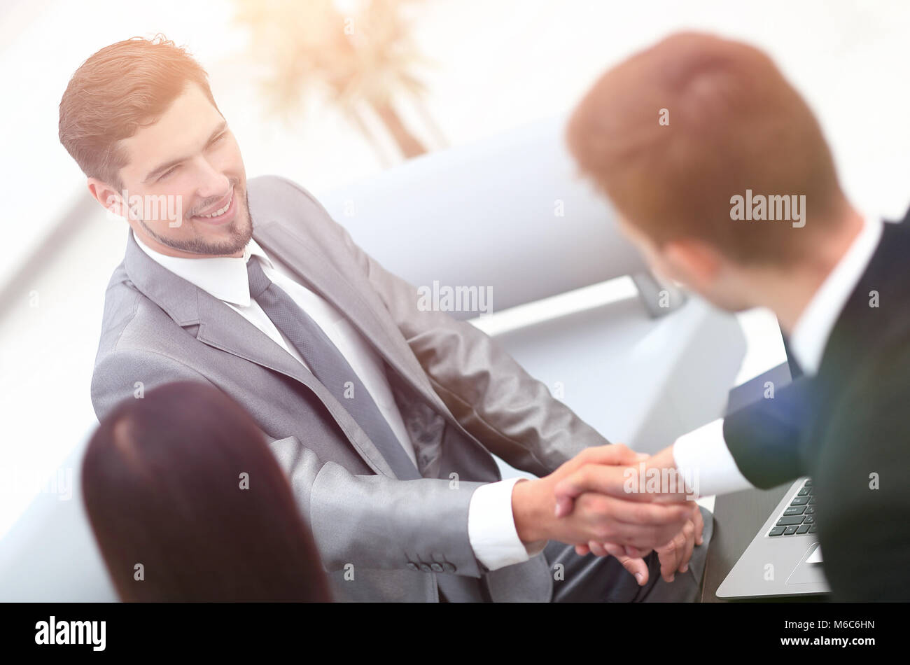 handshake business partners in the lobby of the office Stock Photo - Alamy
