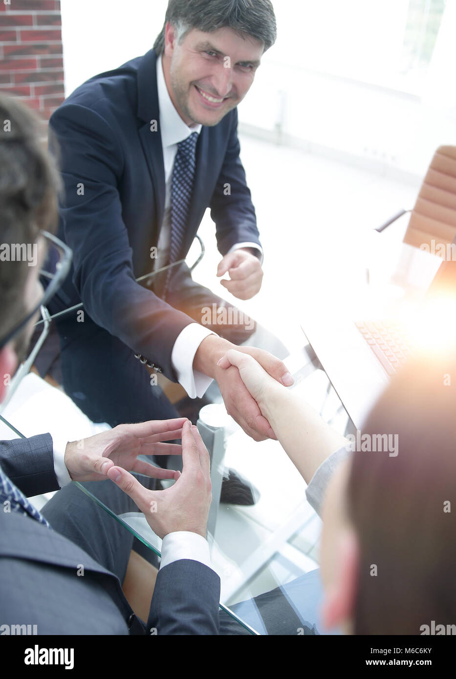 Handshake manager and client at the table Stock Photo - Alamy