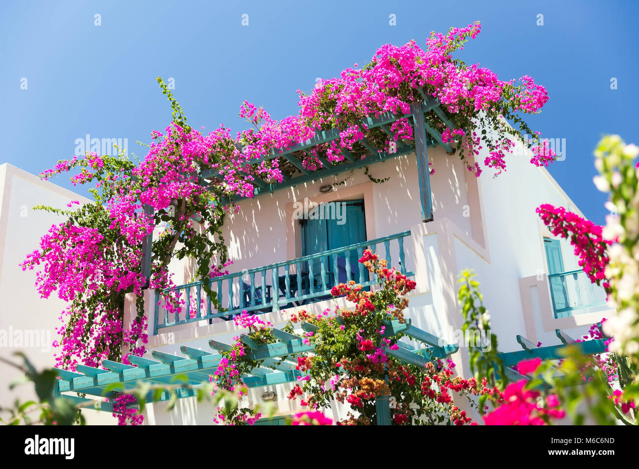 typical greek house with white walls and blue windows on Santorini ...