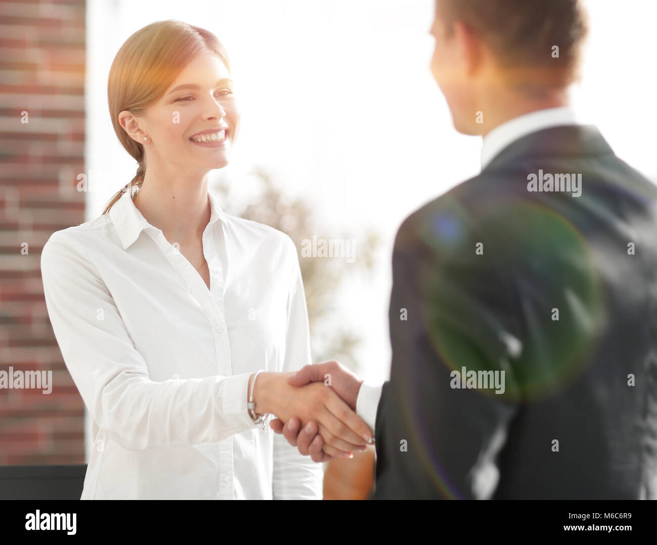 handshake young business woman with a colleague Stock Photo - Alamy