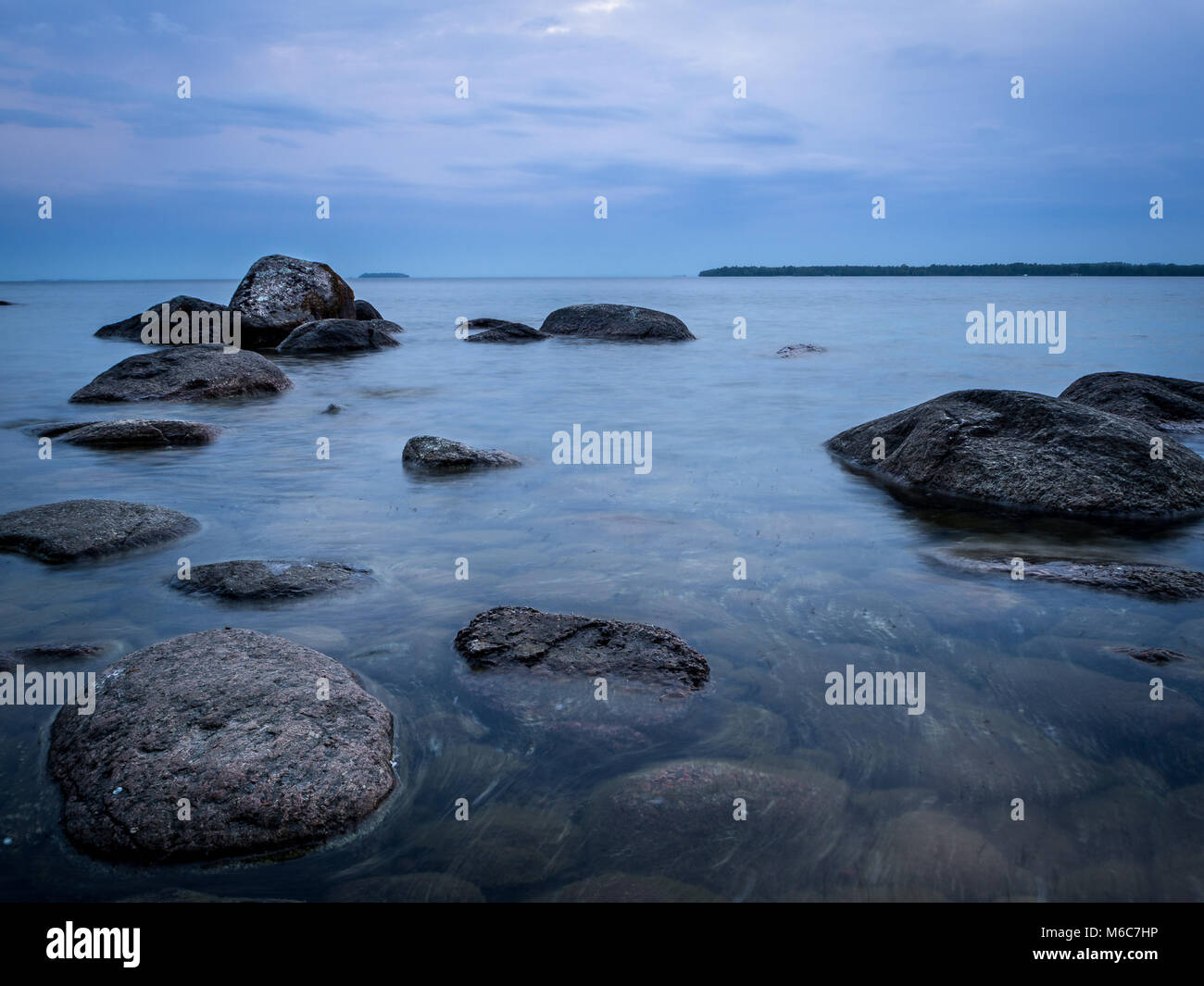Rocks at lake Stock Photo - Alamy