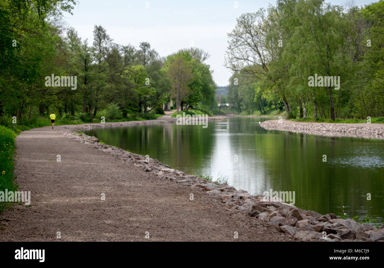 Man running by river Stock Photo - Alamy