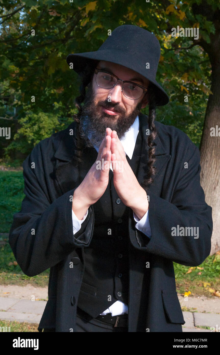 Sunny outdoor portrait of a young smiling happy fingers blessing ...