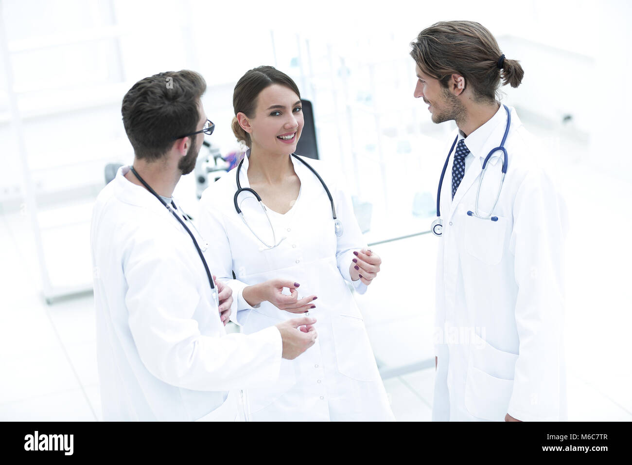 Team of different doctors having conversation Stock Photo - Alamy