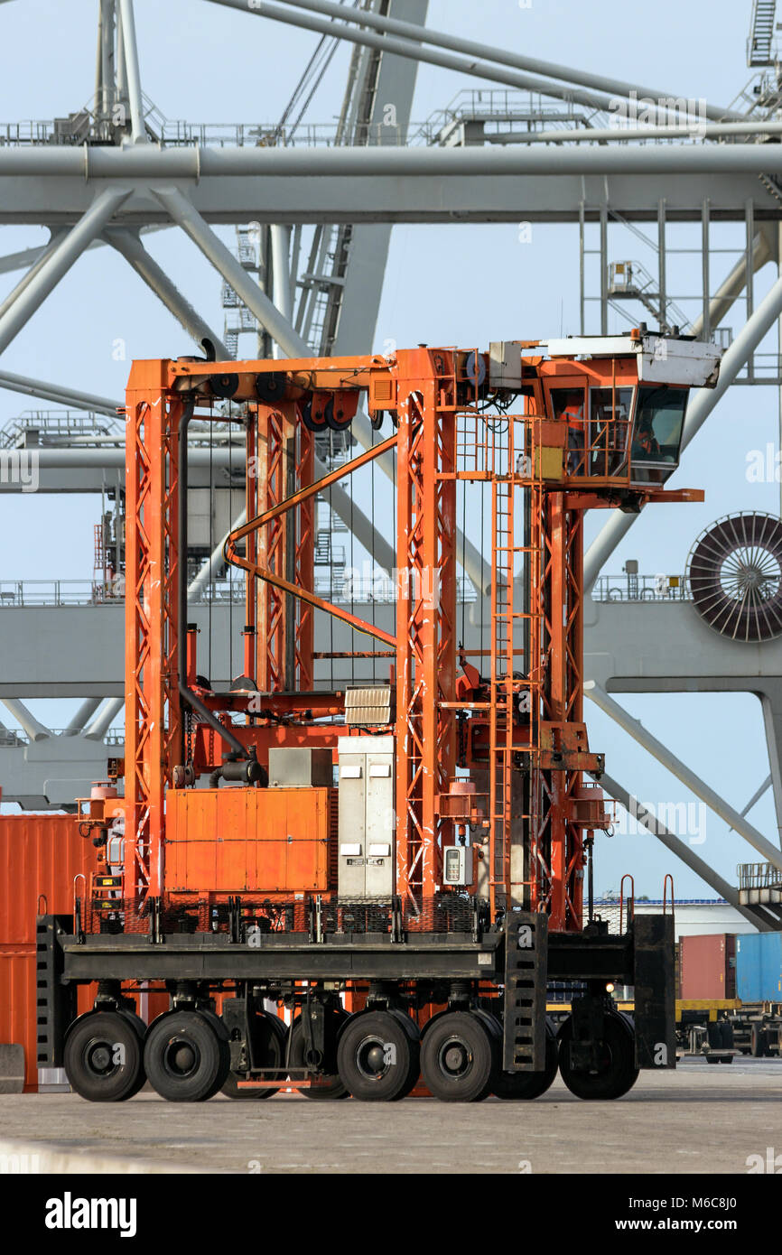 Straddle carrier moving cargo containers in a shipping terminal Stock ...
