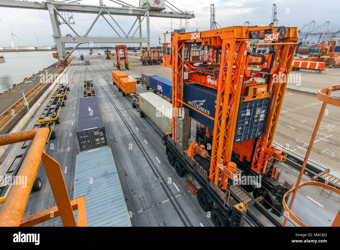 ROTTERDAM, NETHERLANDS - SEP 8, 2013: Straddle carriers moving cargo ...