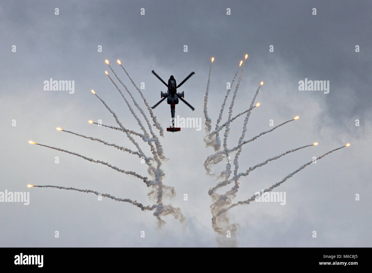 Helicopter in flight firing off flares Stock Photo - Alamy