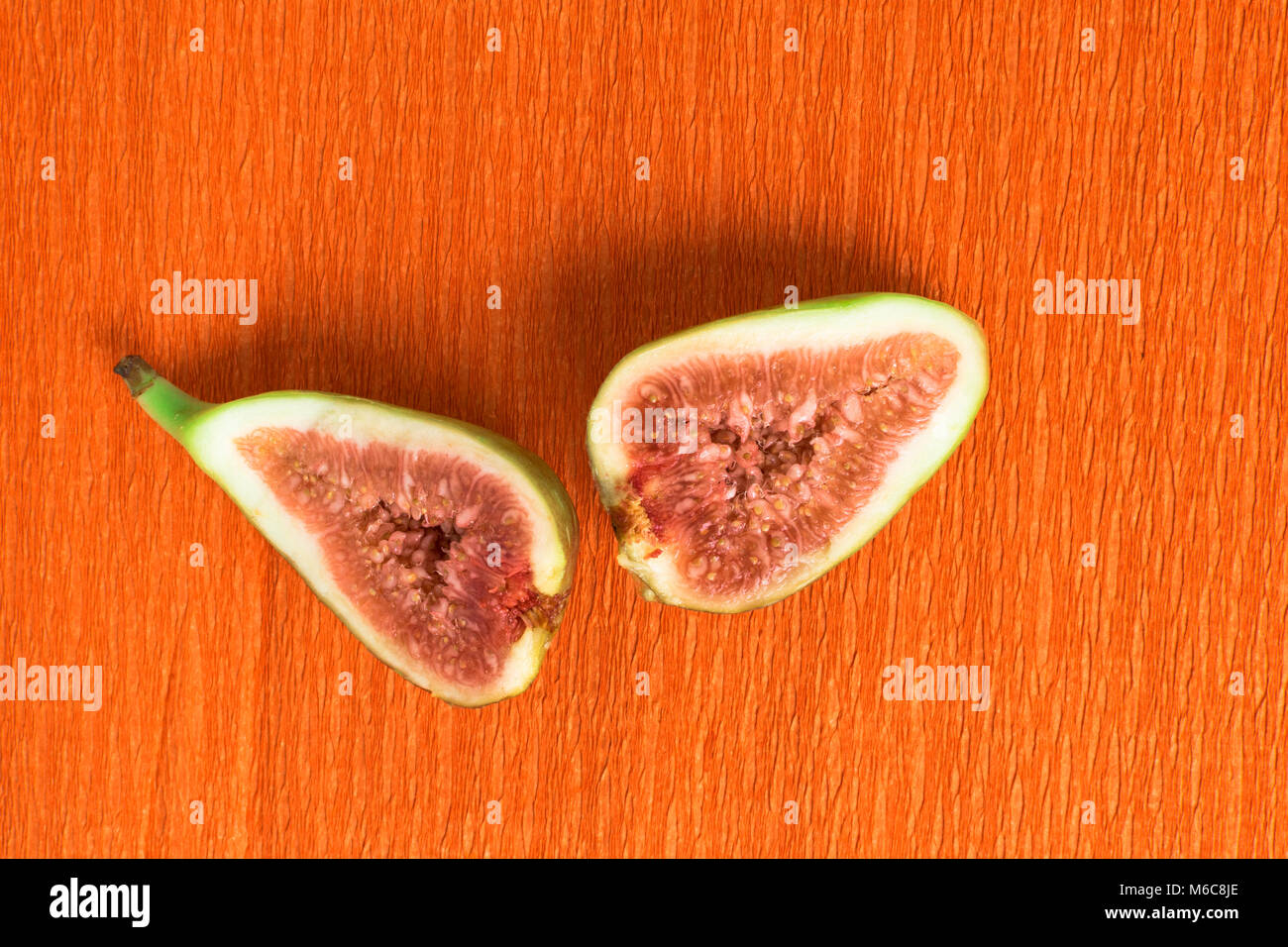 fresh bio figs fruits on the orange background Stock Photo - Alamy