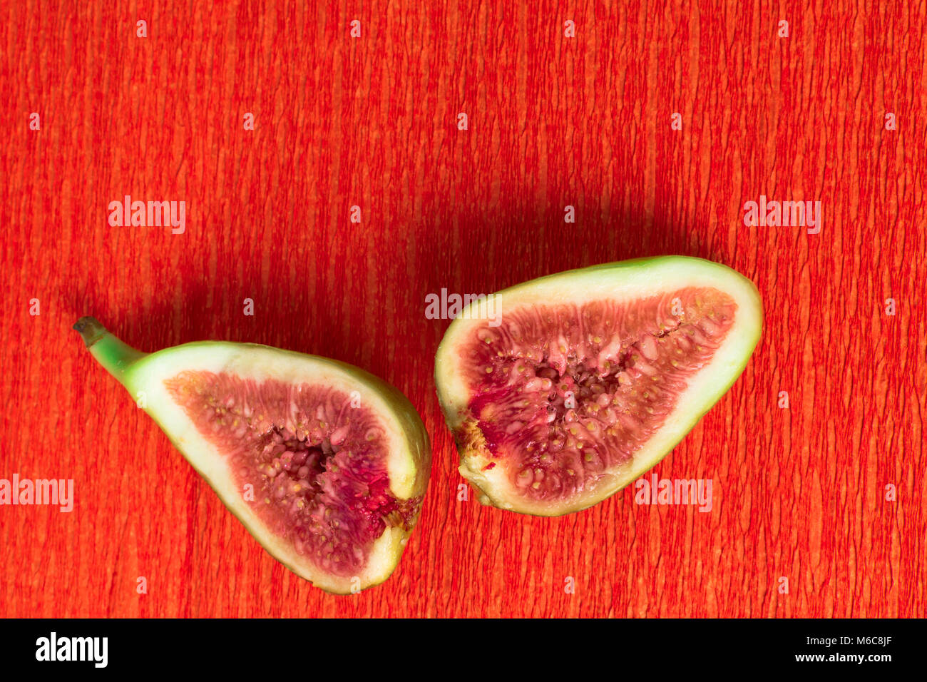 fresh bio figs fruits on the orange background Stock Photo - Alamy