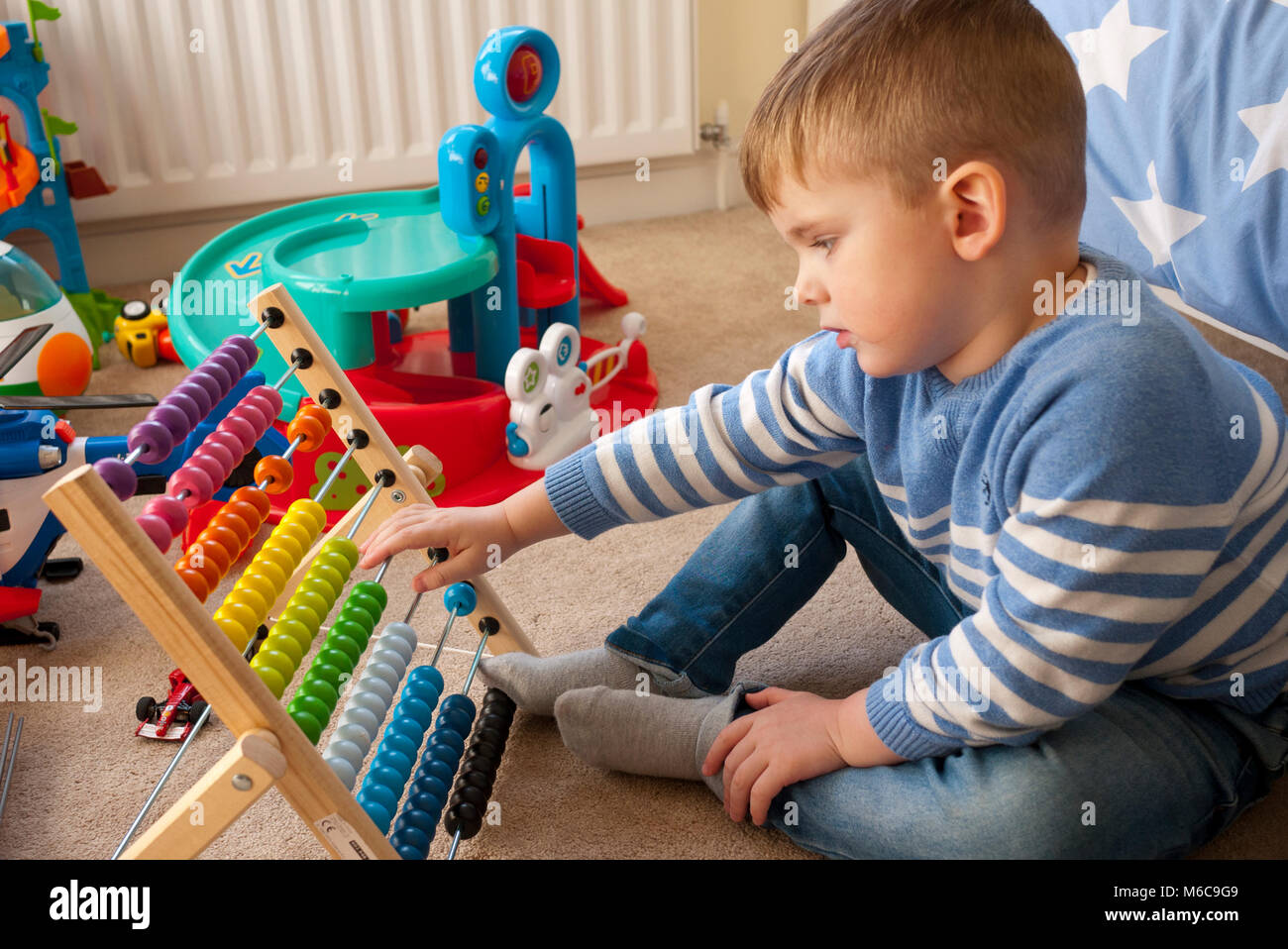 Three year old boy counting on an Abacus, UK Stock Photo - Alamy