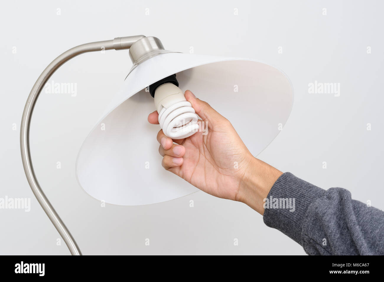 closeup hand changing an electric light bulb Stock Photo - Alamy