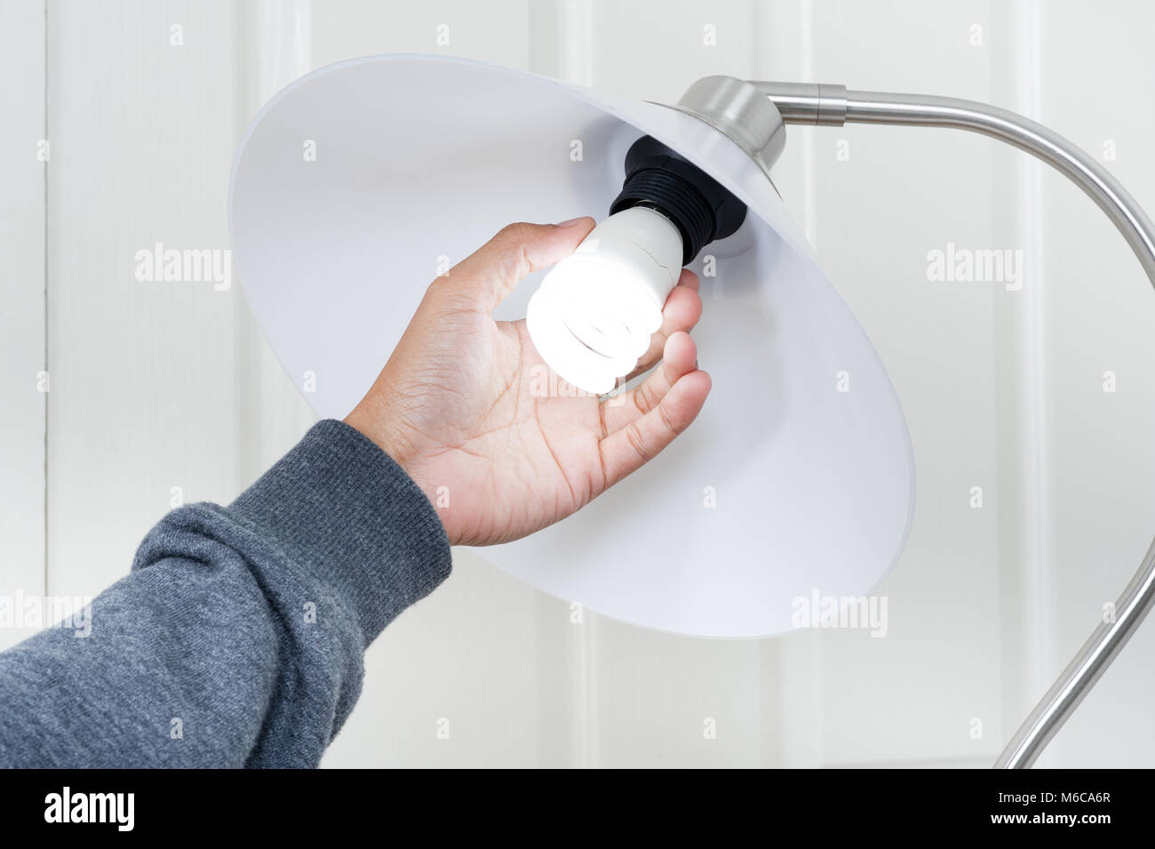 closeup hand changing an electric light bulb Stock Photo - Alamy