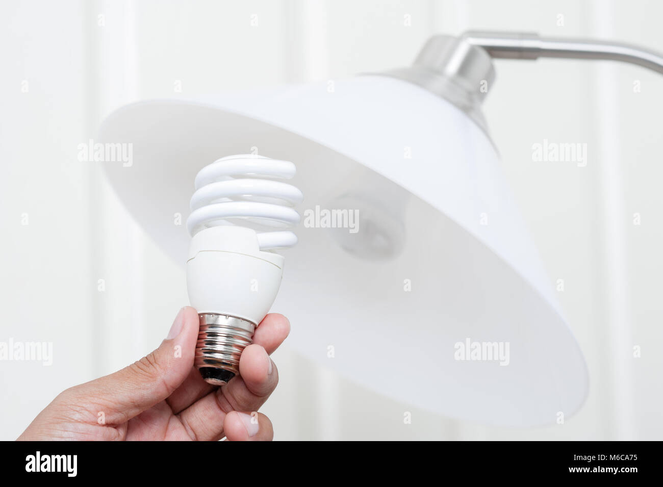 closeup hand changing an electric light bulb Stock Photo - Alamy